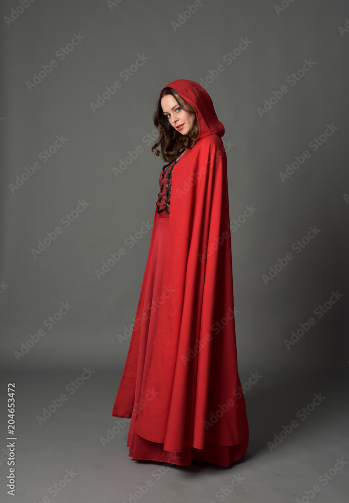 full length portrait of woman wearing red fantasy costume with cloak ...