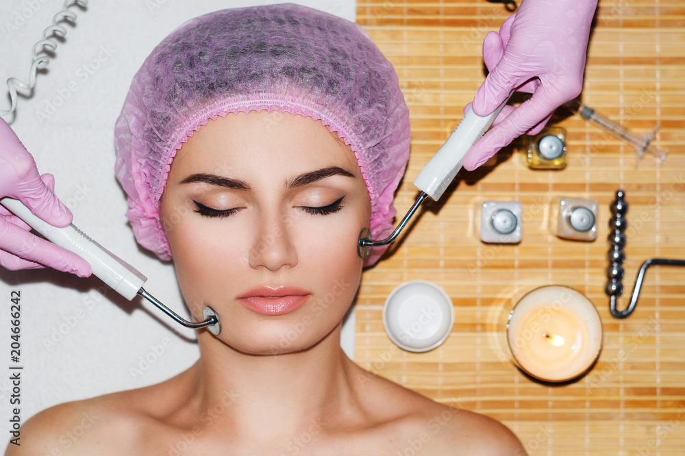 Beautiful woman makes the procedure of smoothing of wrinkles ...