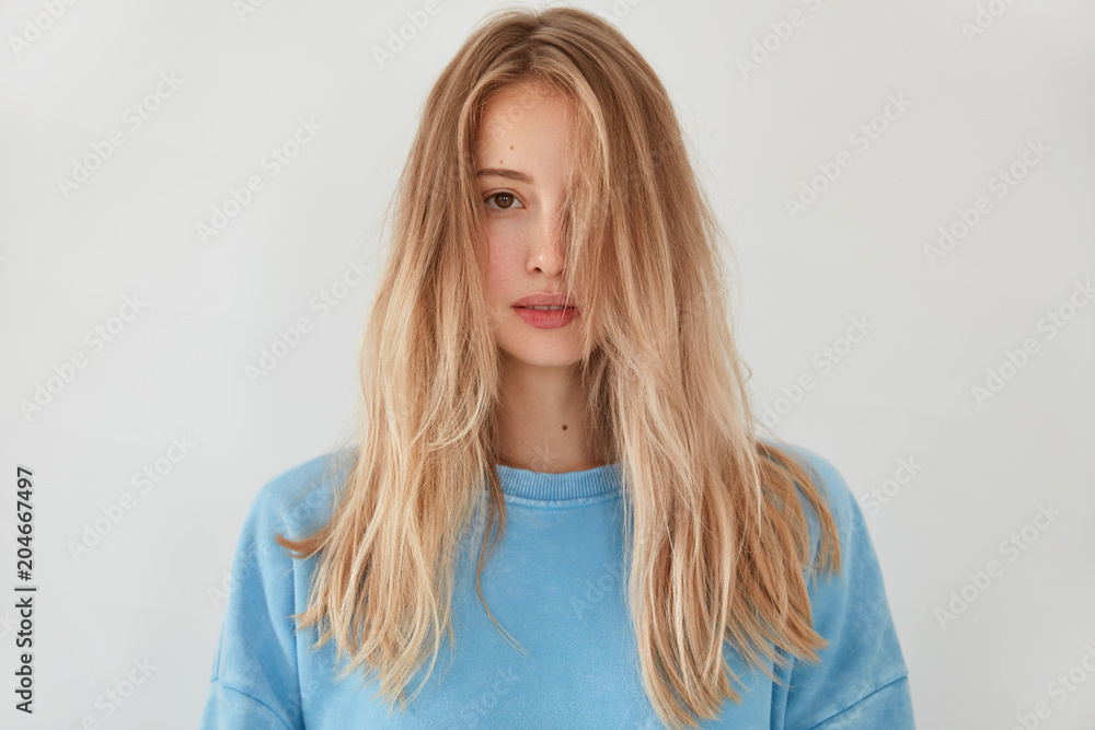 Lovely Caucasian female with long straight light hair, wears blue ...