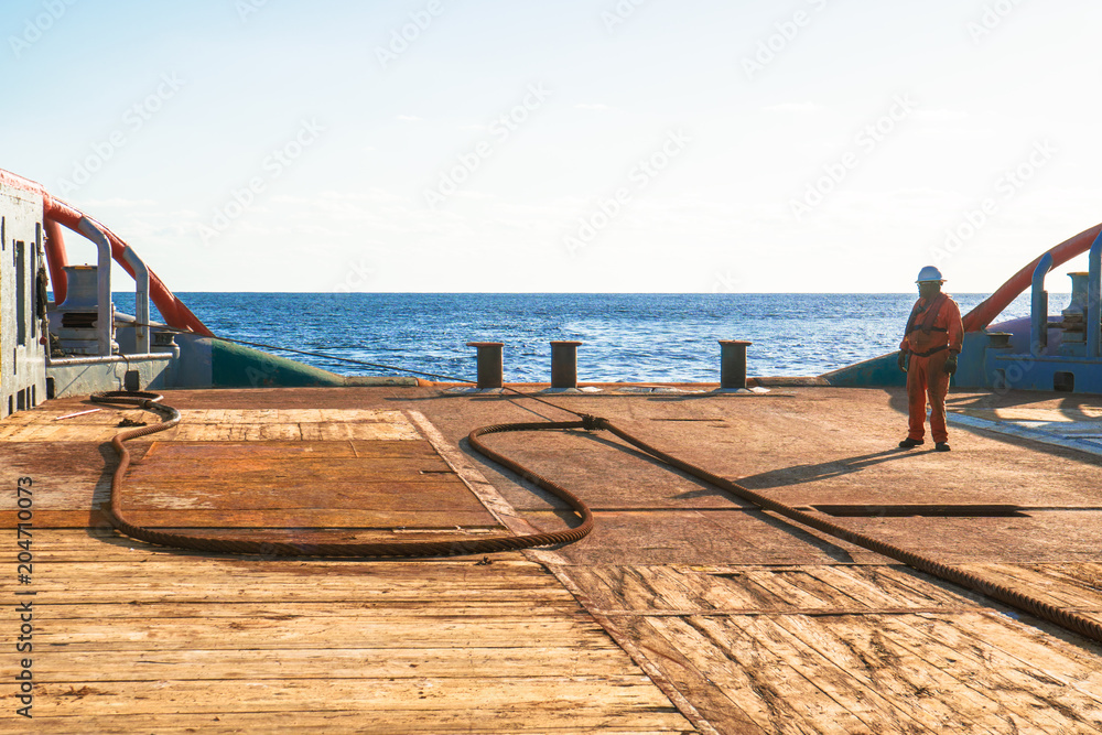 Anchor-handling Tug Supply AHTS vessel crew preparing vessel towing ...
