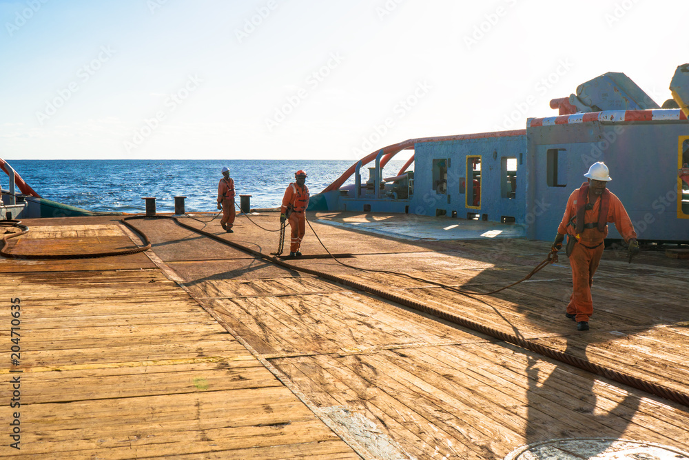 Anchor-handling Tug Supply AHTS vessel crew preparing vessel for static ...