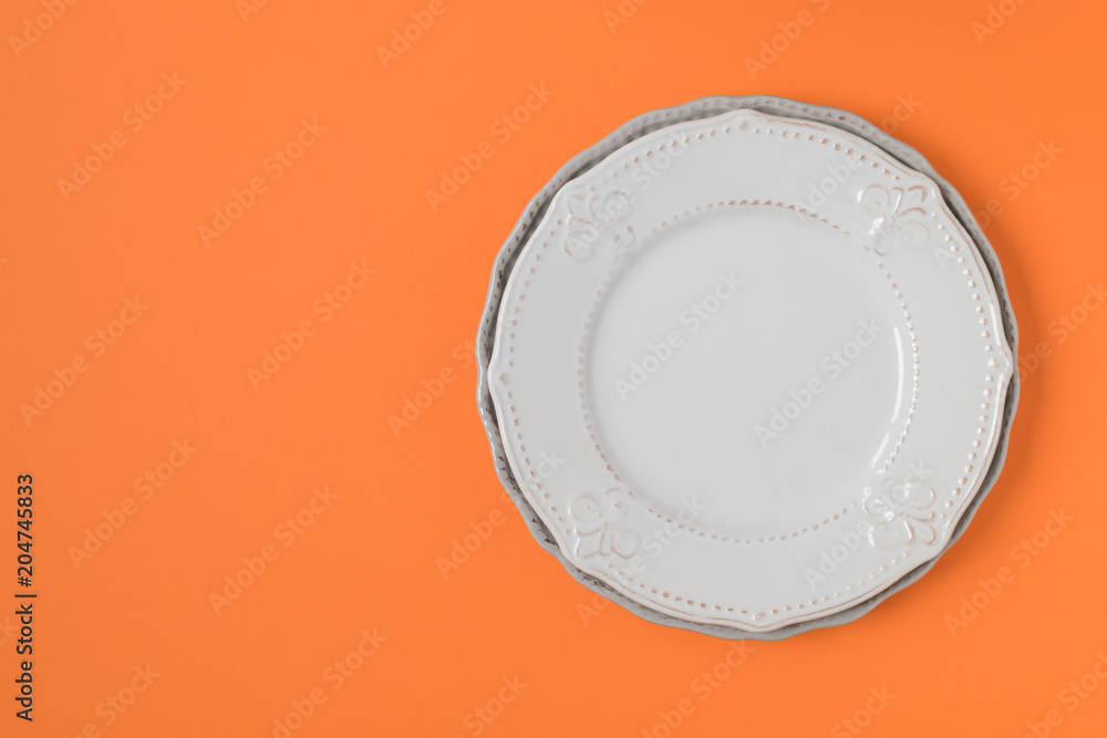 Two rustic plates on yellow background. Plates on the right side of ...