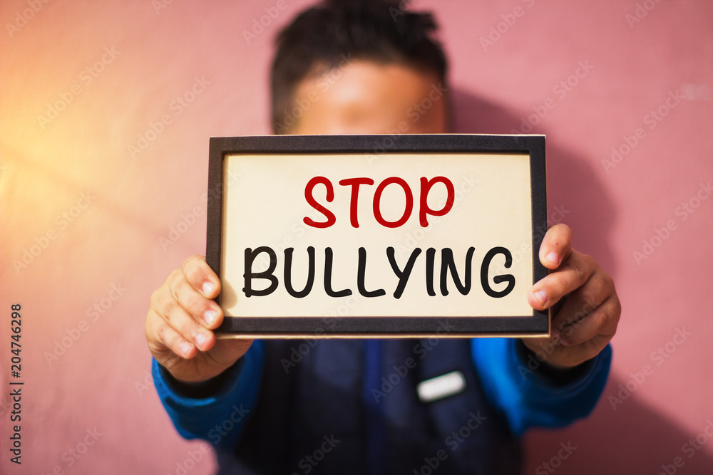 Little boy holding cardboard with text stop bullying - victim children ...