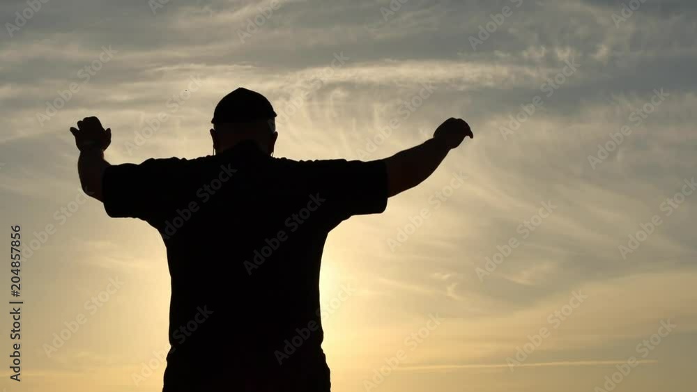 man surrender and drops knife and pistol silhouette at sky background ...