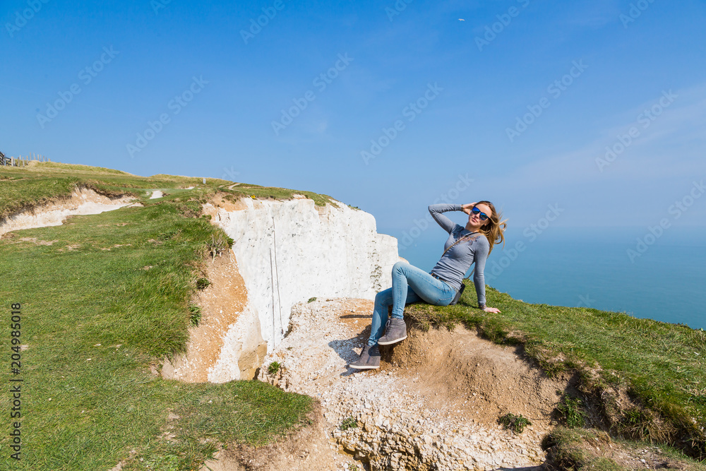 Girl hiking at the edge of the white cliff of Dover in United Kingdom Stock Photo | Adobe Stock
