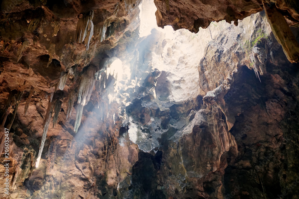 Stalagmite ,stalactite, limestone and tunnel with beam sunlight at Khao ...