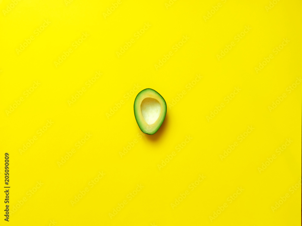 Avocado without seed isolated in yellow background viewed from above ...
