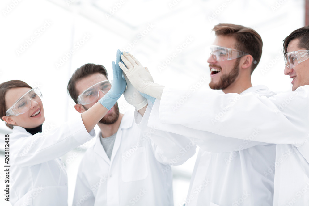 scientists giving each other a high five Stock Photo | Adobe Stock