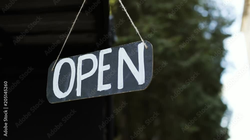 open sign is hanging in front of store entrance signbroad of opened ...