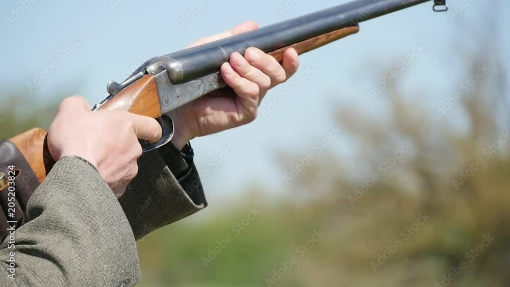 Closeup of a rifleman with a single barrel rifle targeting, pulling the ...