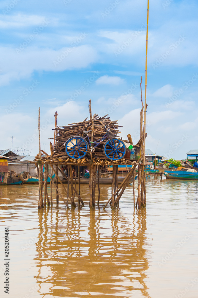 A wooden platform on stilts, appearing like an art object, in the ...