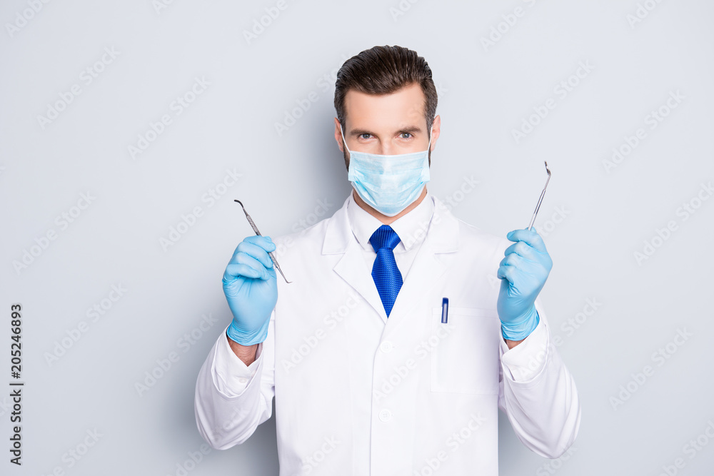 Portrait of successful handsome dentist in white lab coat with blue tie ...
