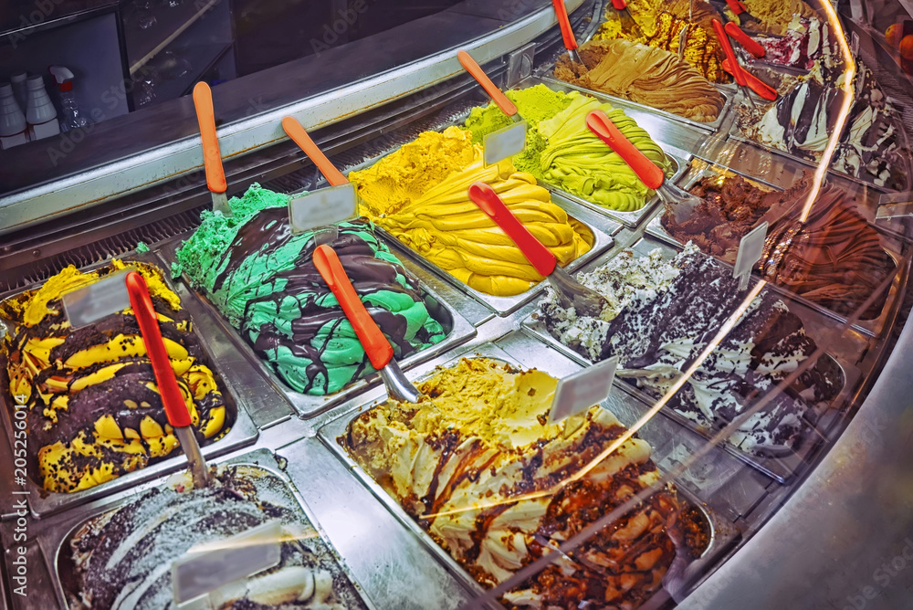 Many boxes of typical classic italian gourmet gelato ice cream display ...