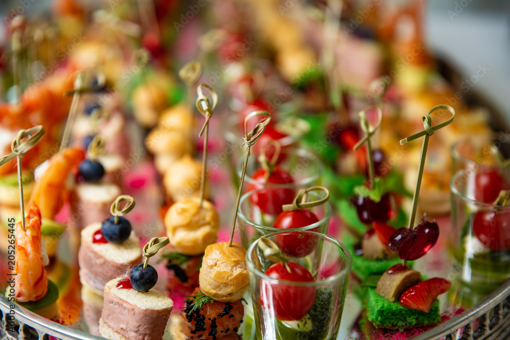 Light snacks, canap s with lard, cheese, meat, sauce, cherry tomatoes ...