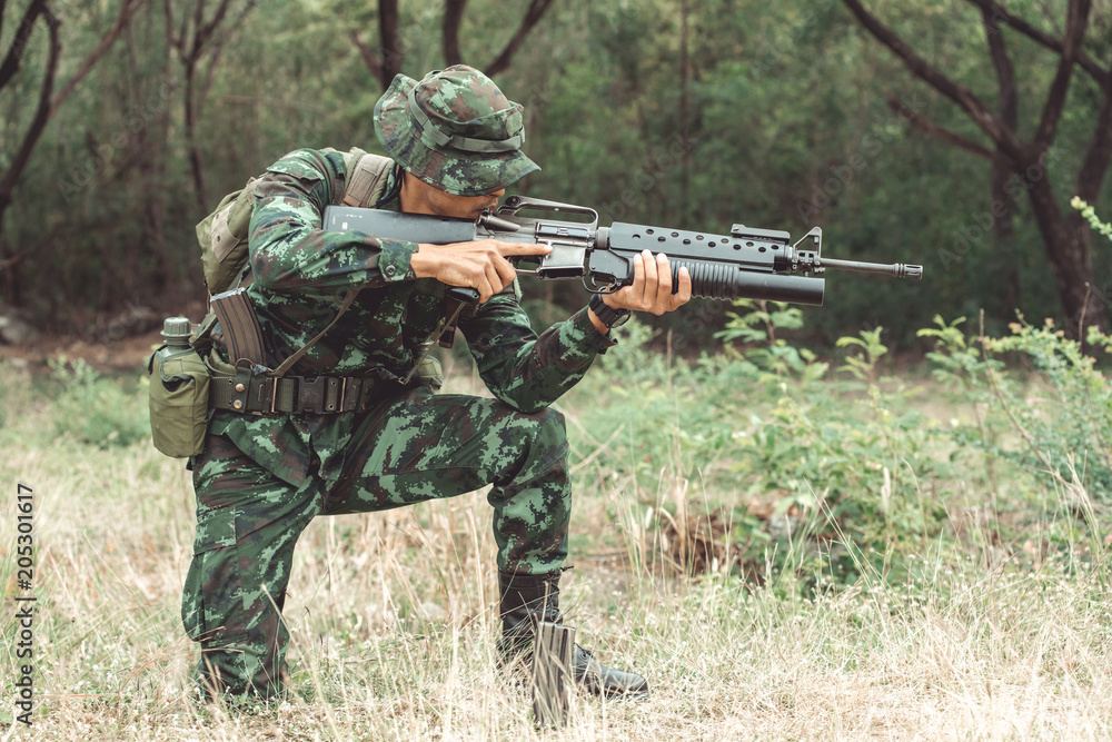 Soldier reloading his assault rifle. Chinese professional soldier ...