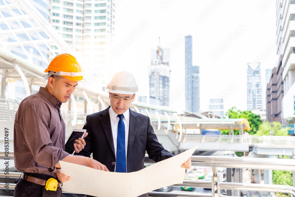 Employee is consulting his engineer boss for solving the problem on ...