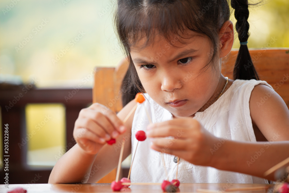 Cute asian child girl playing and creating with play dough and ...
