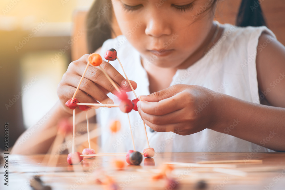 Cute asian child girl playing and creating with play dough and ...