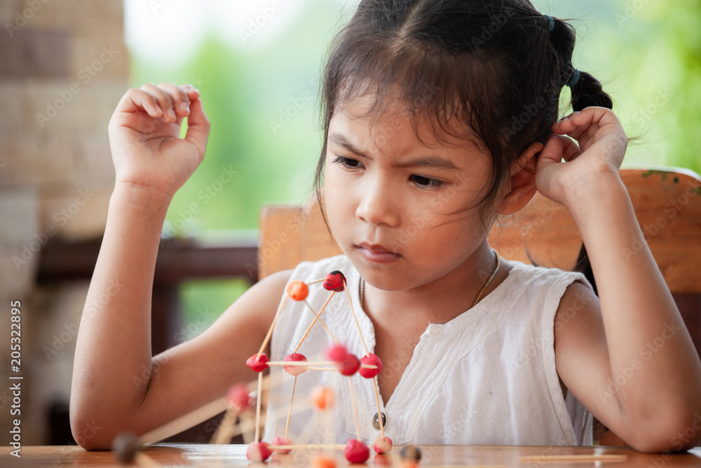 Cute asian child girl playing and creating with play dough and ...