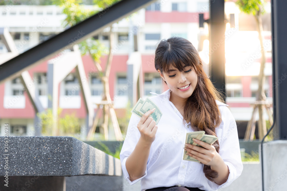 Beautiful woman is counting money or dollars. Lovely girl get first ...