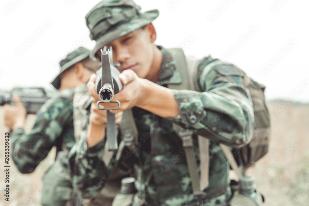 Soldier aiming his weapon. Standing up aiming their assault rifle down ...