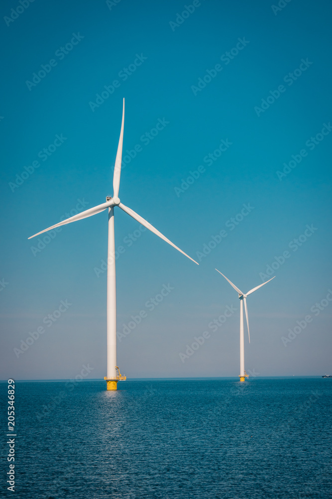Offshore and Onshore Windmill farm in the ocean ,windmills isolated at ...