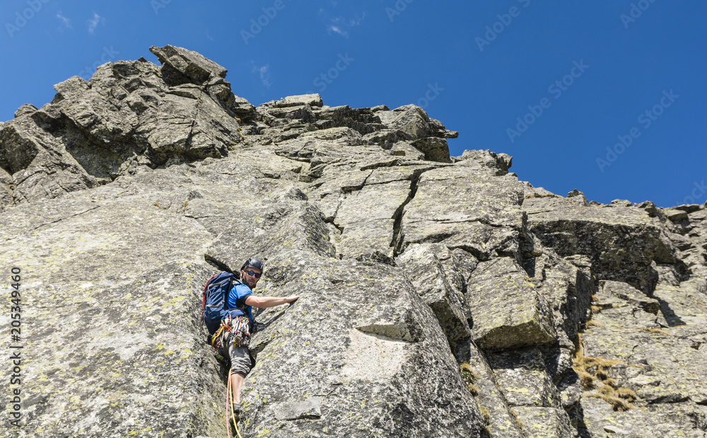 Climber in offwidth, while leading the pitch in the mountains. Stock ...