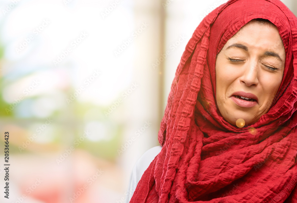 Young arab woman wearing hijab crying depressed full of sadness ...