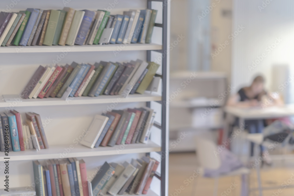 Abstract blurred bookcase with books, manuals in public library and In ...