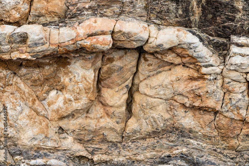 Compressed rock layers formation in various colors and thicknesses, on ...