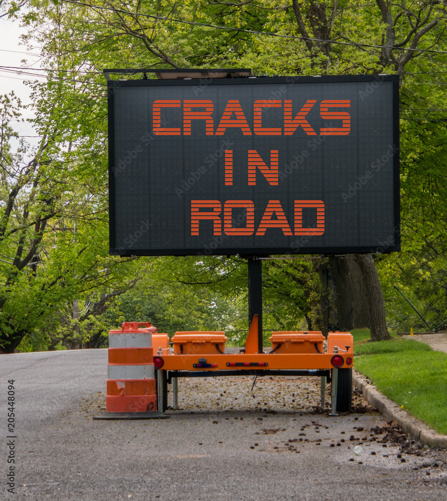 Cracks in road warning sign on trailer due to volcano Stock Photo ...