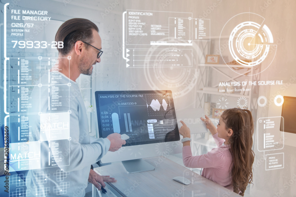 Understanding technologies. Smart progressive girl standing next to her ...