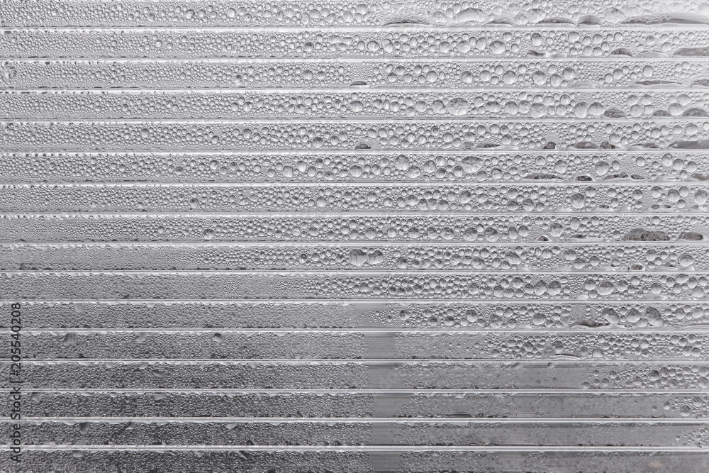 Water drop on reflective clear plastic wrap. The texture of the drops ...