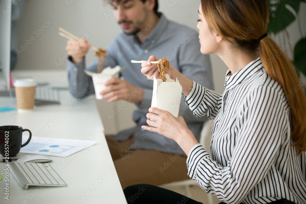 Office people eating chinese noodles holding boxes at lunch time, young ...
