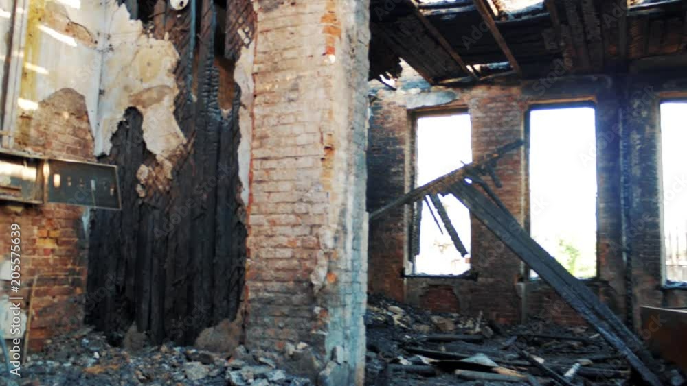 Ruins of burned brick house after fire disaster accident. Heaps of ash ...