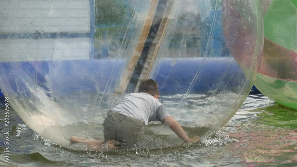 child has fun on the playground. Child in sodium, water ball. little ...