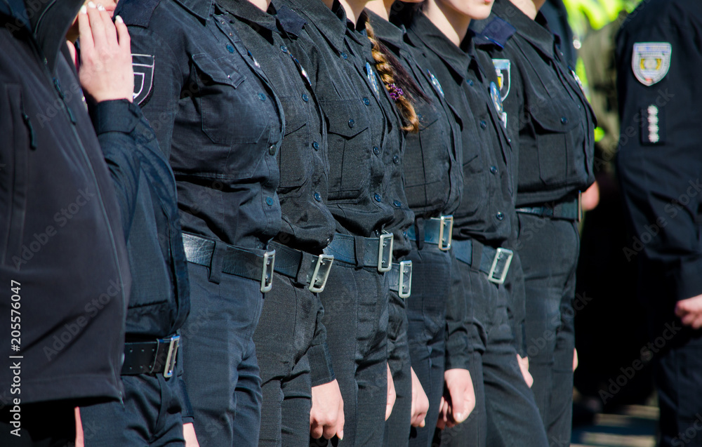 Female police officers in black uniform standing in a row Stock Photo ...