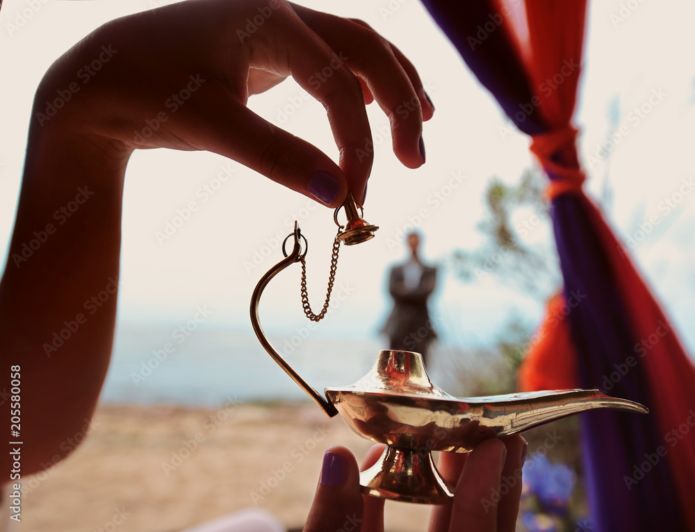 Magic lamp in the desert from the story of Aladdin with Genie concept ...