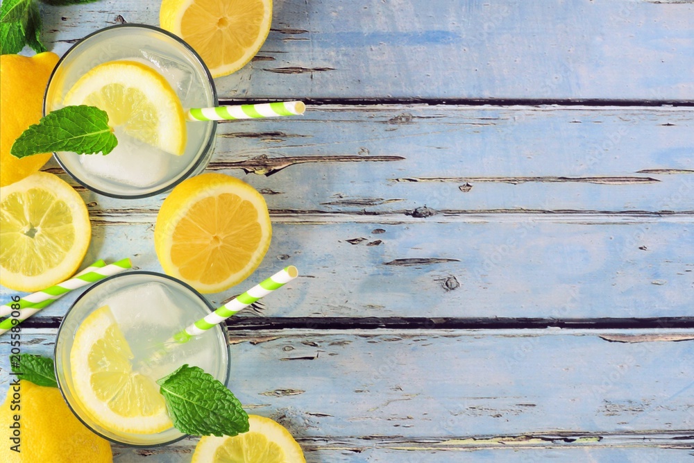Sweet summer lemonade. Top view side border with copy space on a rustic ...