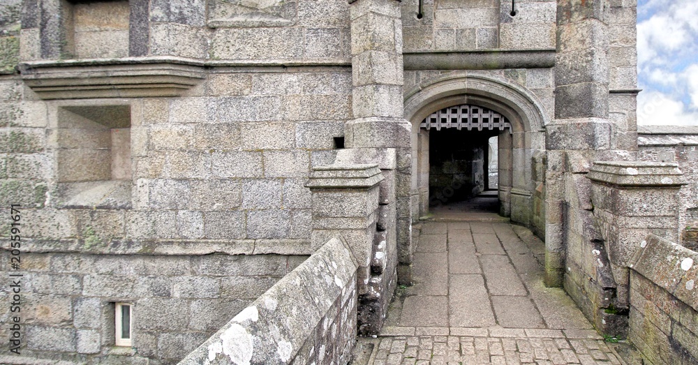 Entrance to an old stone walled castle with portcullis Stock Photo ...