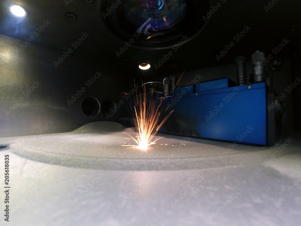 3D printer printing metal. Laser sintering machine for metal. Metal is ...