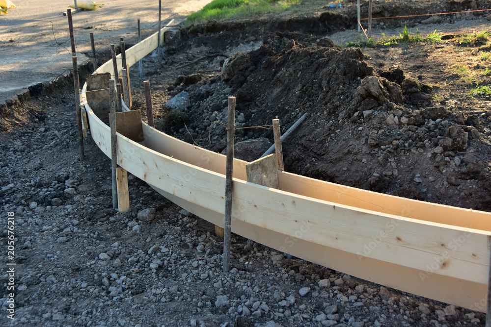 Wood forms installed ready for concrete pour for new curb and gutter ...