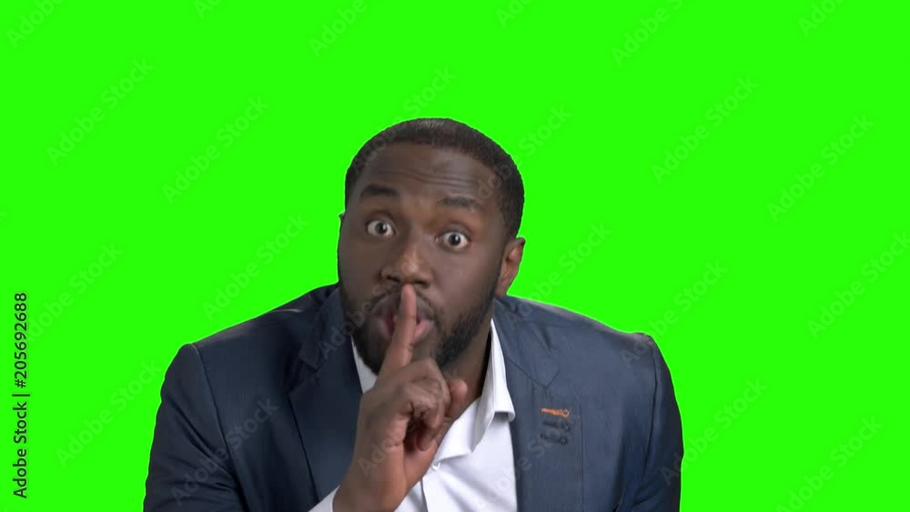 Afro-american businessman showing silence gesture. Portrait of young ...