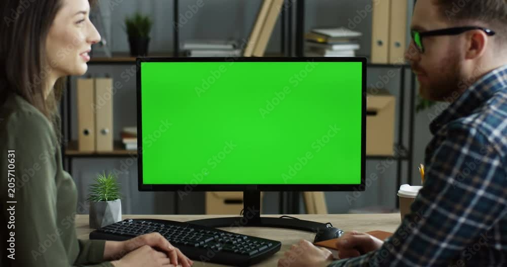 View from behind on the male and female office workers sitting at the ...