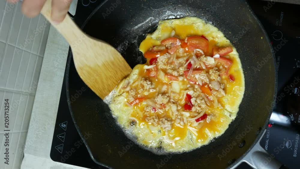flip over cooking omelet, chicken egg with mince pork , red onion ...