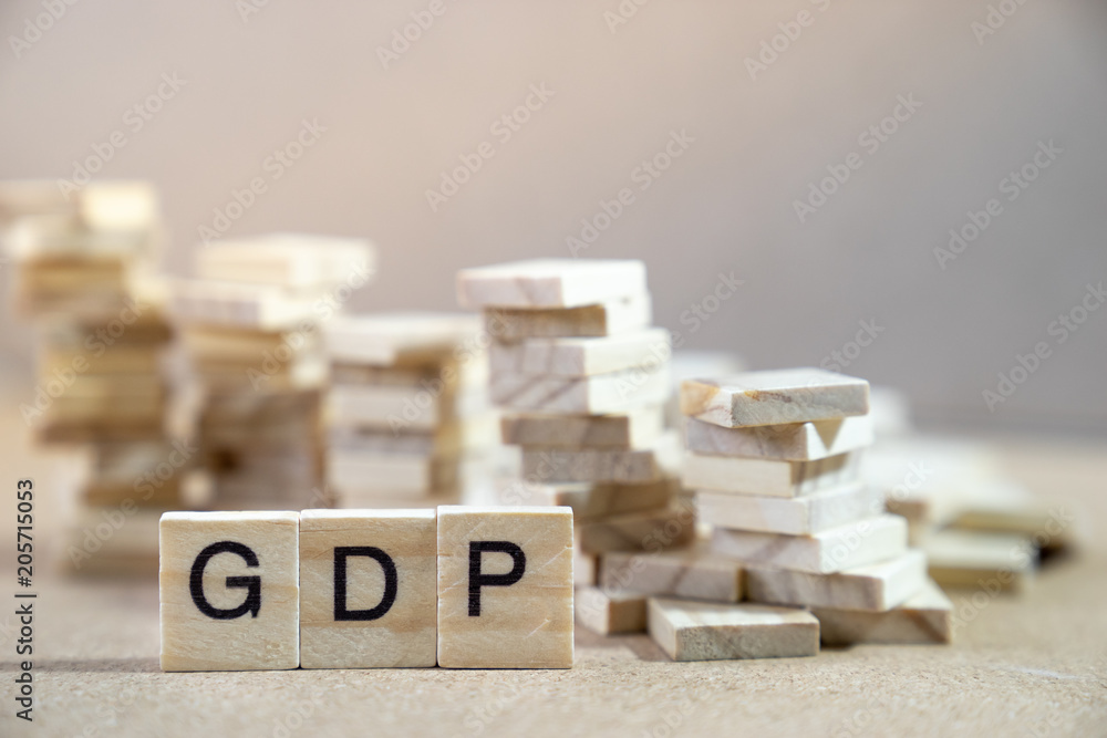 GDP Word Written In Wooden Cube on wood table with wooden stack as ...