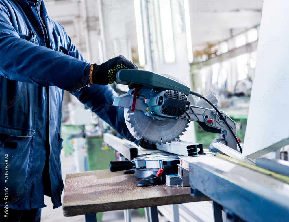 Cutting PVC profile with circular saw. Industrial equipment. PVC ...