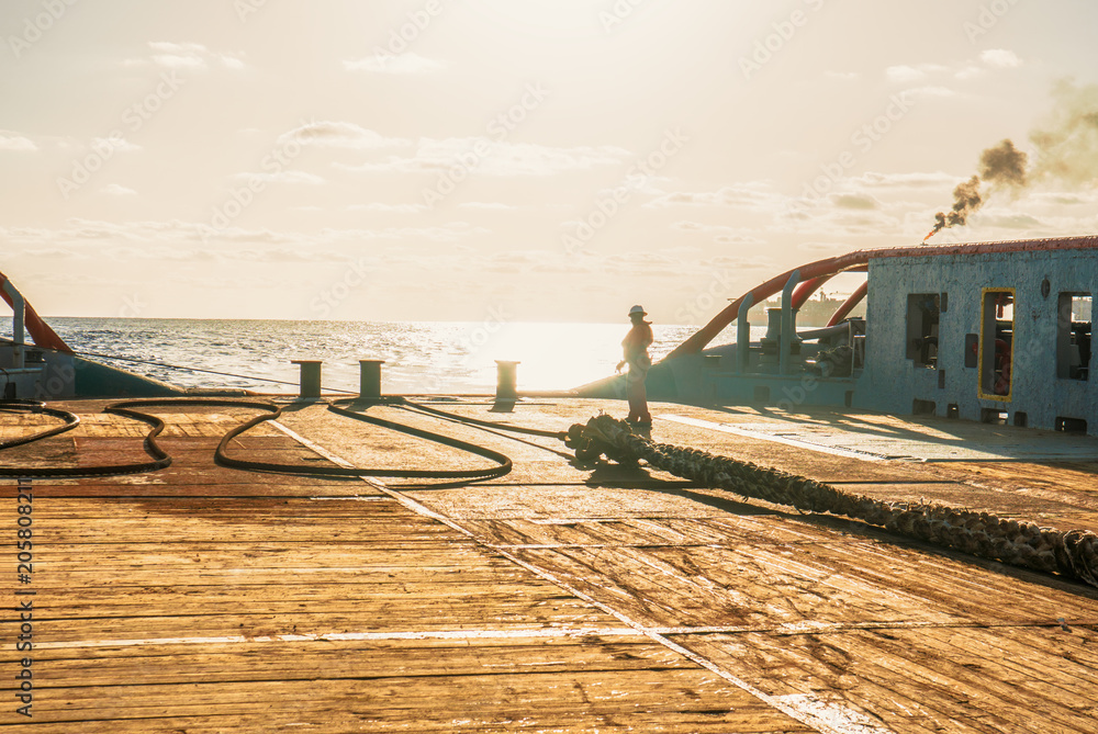Anchor-handling Tug Supply AHTS vessel crew preparing vessel towing ...