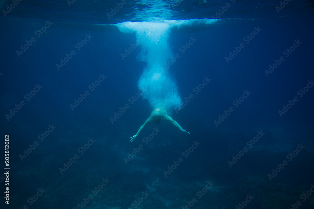 partial view of man diving into ocean foto de Stock | Adobe Stock