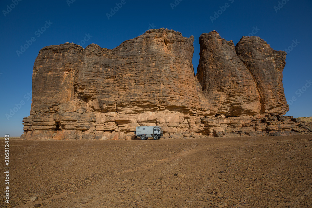 Camp with 4x4 expedition verhicle at massive rock formation ...